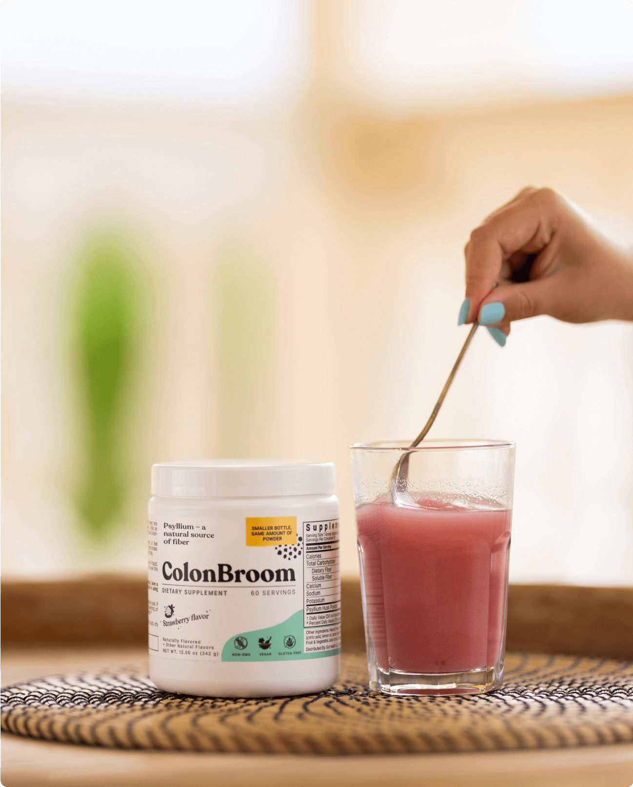 Woman stirring Colonbroom in a glass